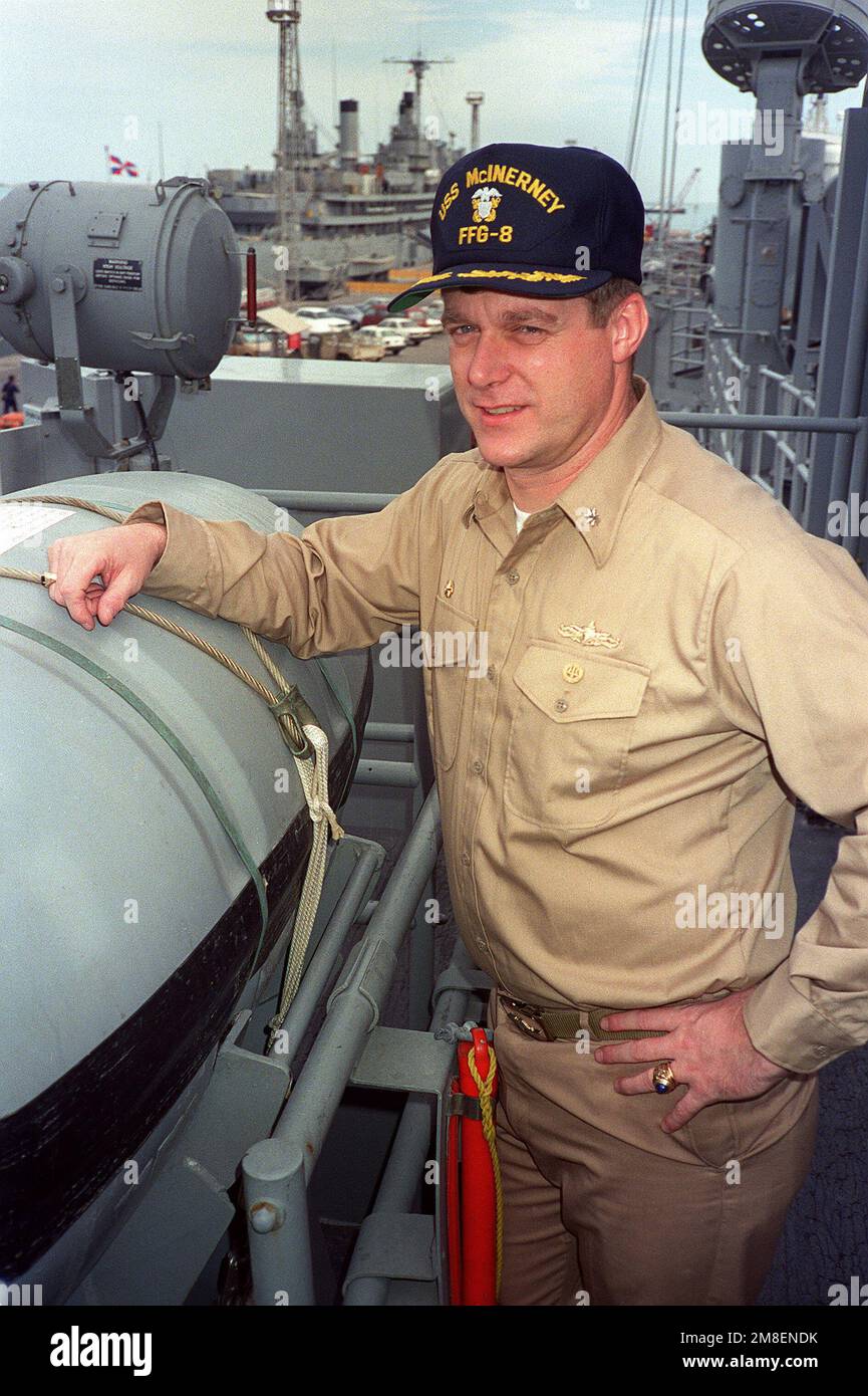 CMDR. Clarence E. Hill stands aboard the guided missile frigate USS ...