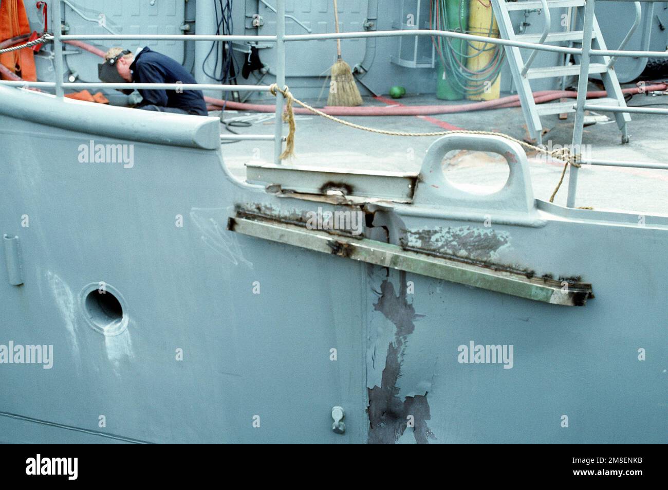 A close-up view of a crack in the hull of the Aegis guided missile ...
