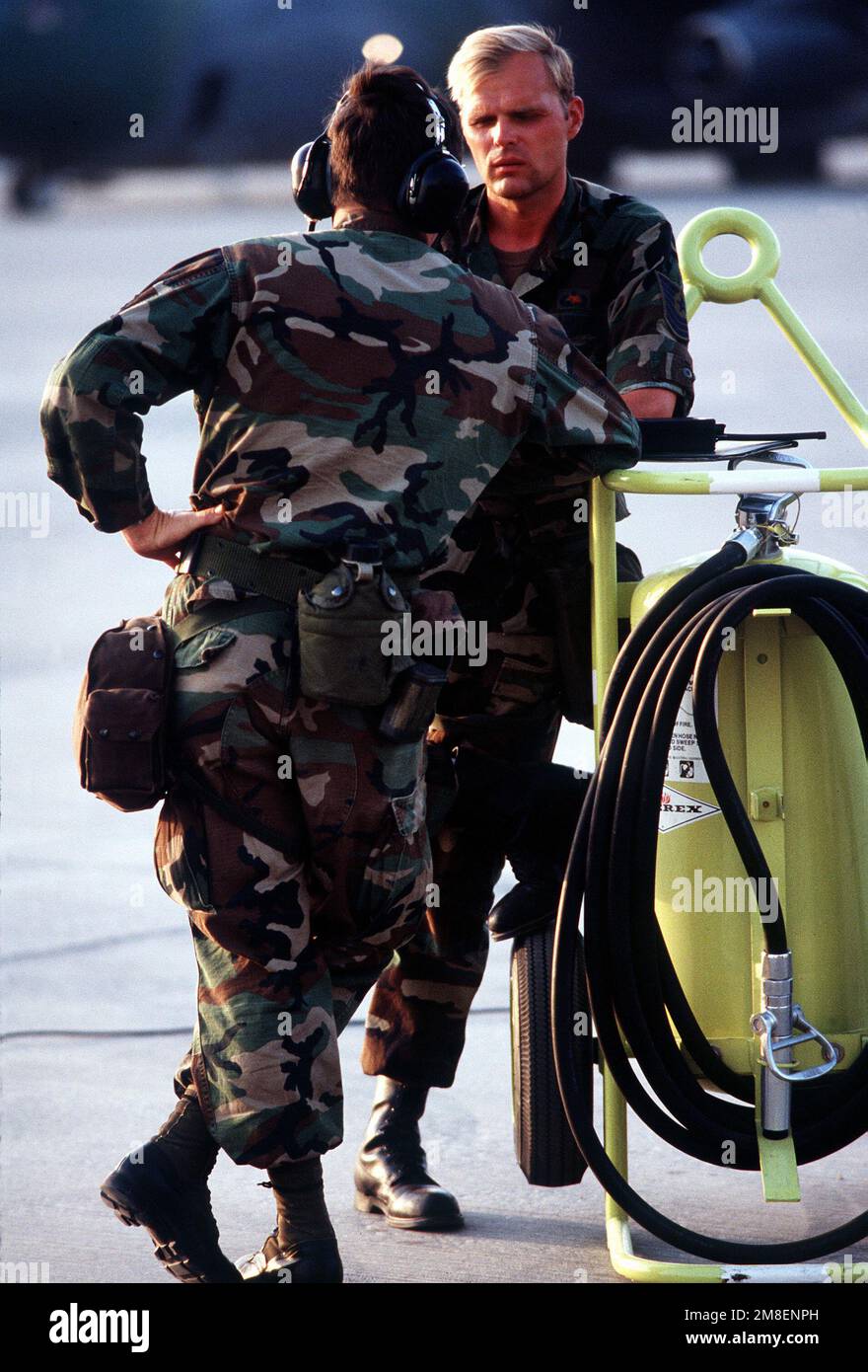 Ground crew members converse during a break from readying C-5A Galaxy ...