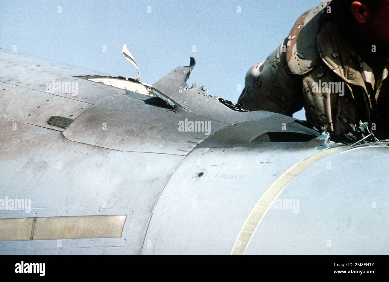 A view of the damage to the fuselage of an F/A-18 strike fighter ...