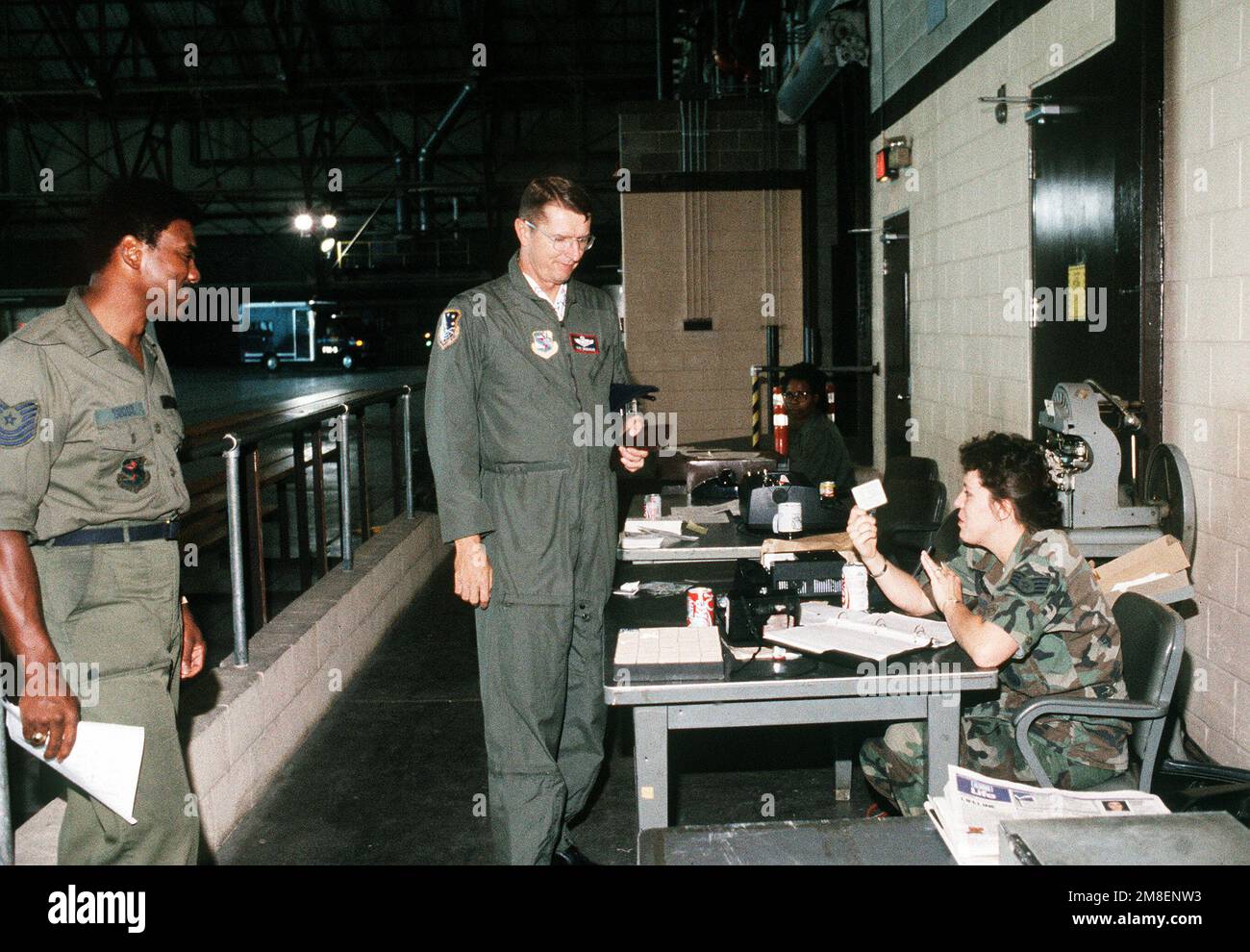 A processor reviews identification and records with an air crew member ...