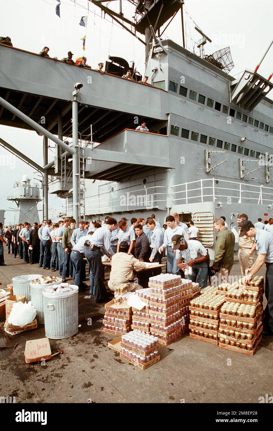 Crewmen aboard the amphibious command ship USS BLUE RIDGE (LCC-19) line ...