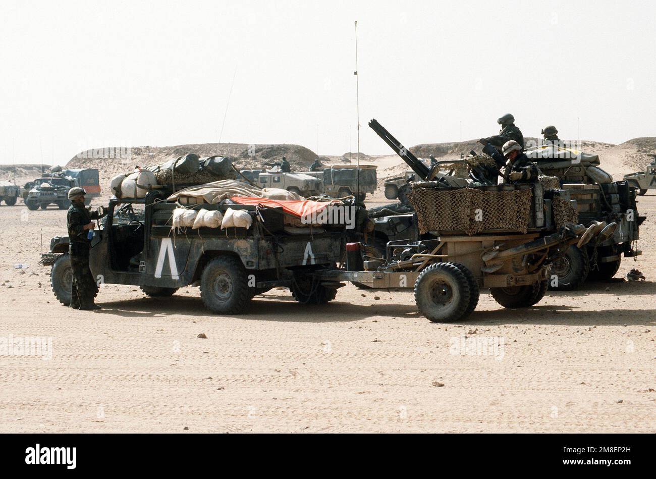 U.S. military personnel prepare to move out in a convoy of M-998 high ...