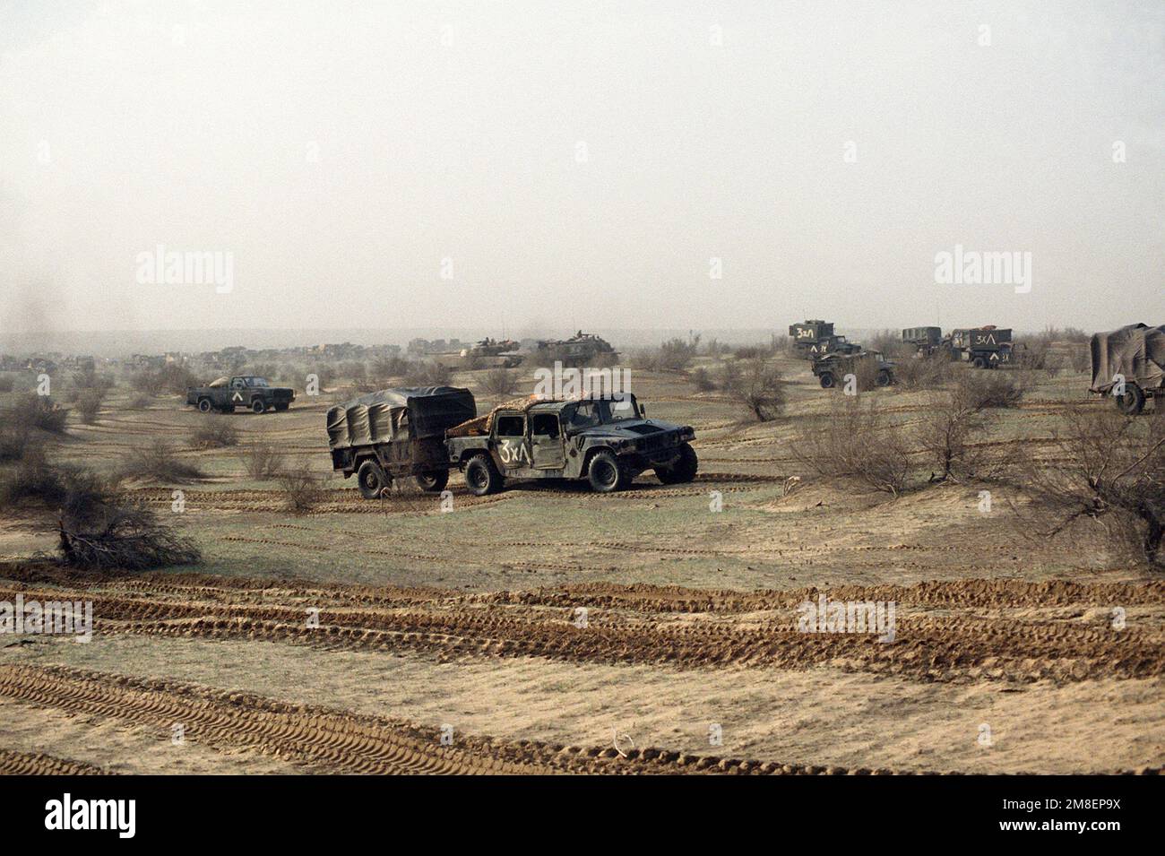 An M-998 high-mobility, multipurpose, wheeled vehicle, towing a cargo ...