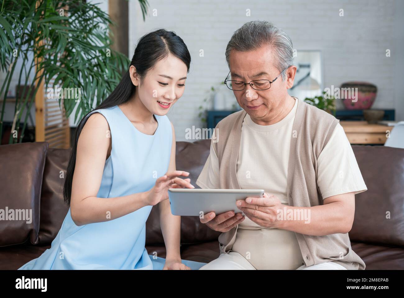 Father and daughter two people use tablet computers Stock Photo - Alamy