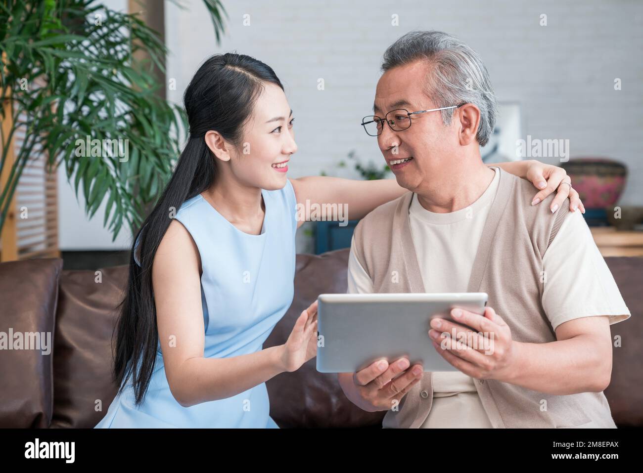 Father and daughter two people use tablet computers Stock Photo - Alamy