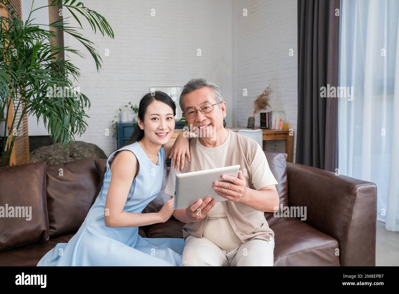 Father and daughter two people use tablet computers Stock Photo - Alamy