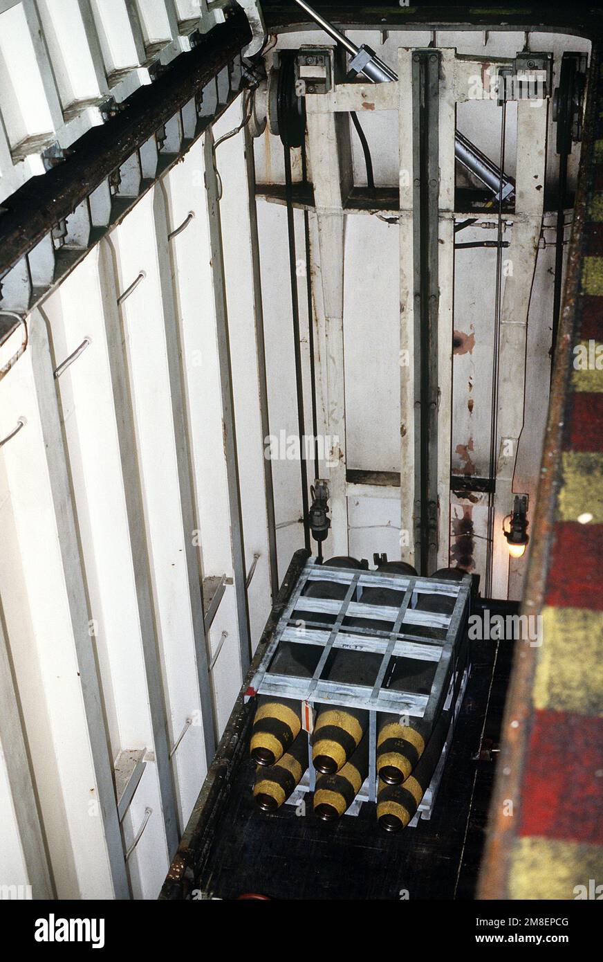 The hangar deck elevator lifts Mark 82 500-pound bombs from magazines ...