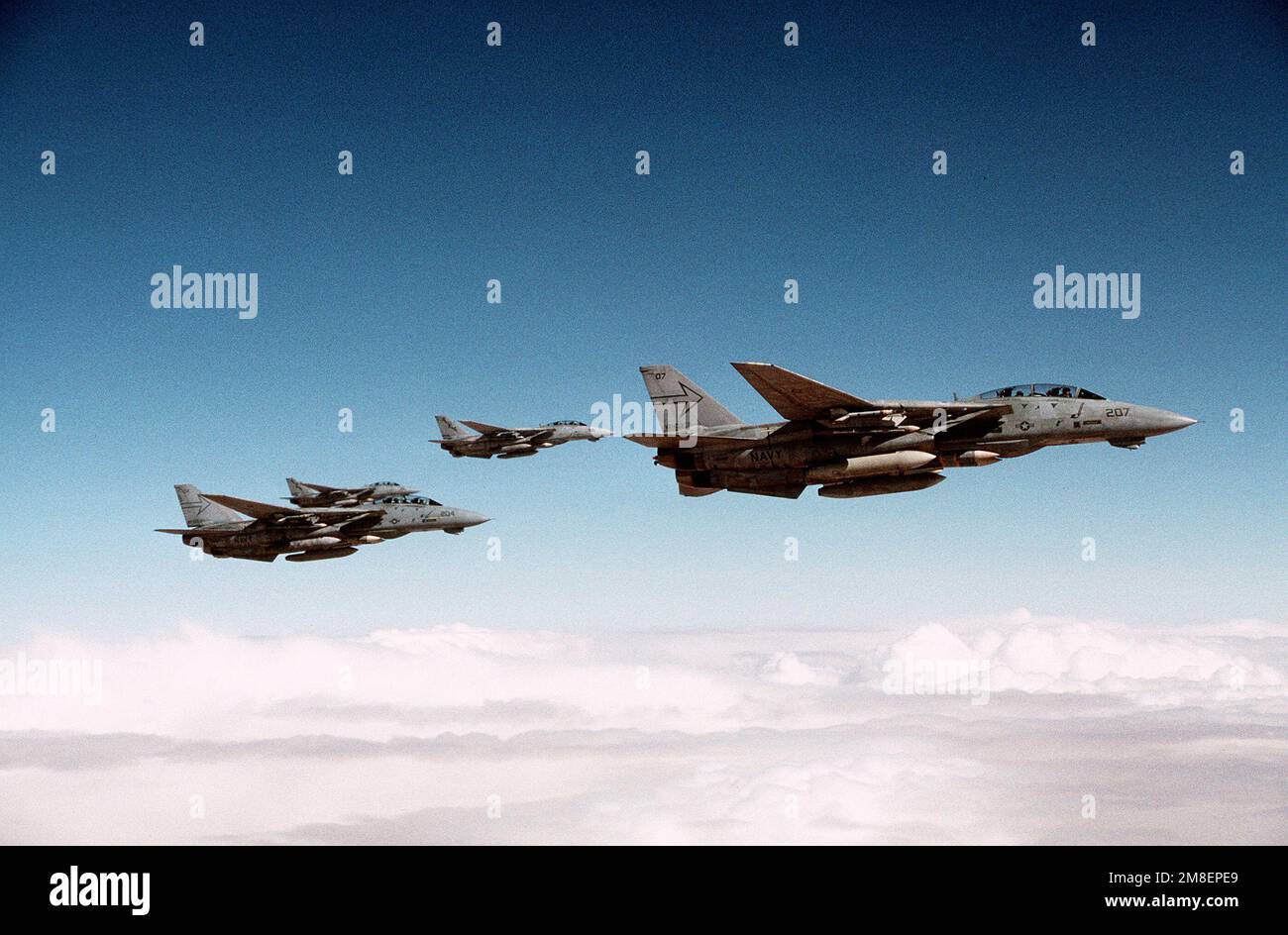 F-14A Tomcat aircraft fly in formation as they prepare for refueling during Operation Desert ...