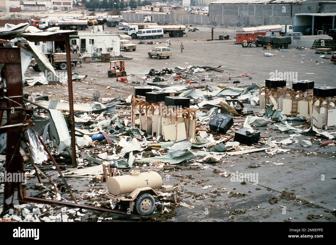 Clean-up proceeds at the site where a warehouse was hit by an Iraqi ...