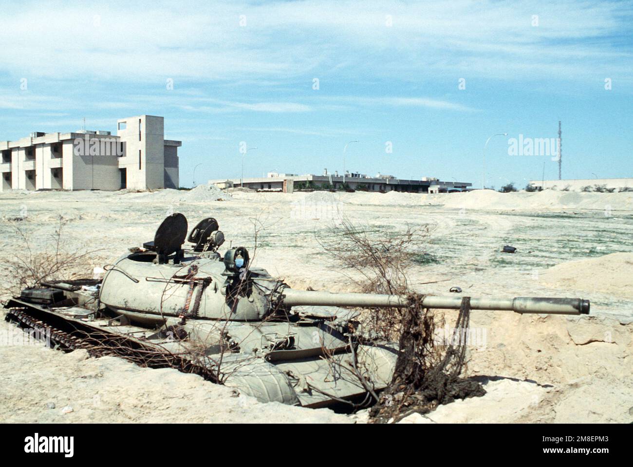 An Iraqi T-55 main battle tank lies abandoned near a field after the ...