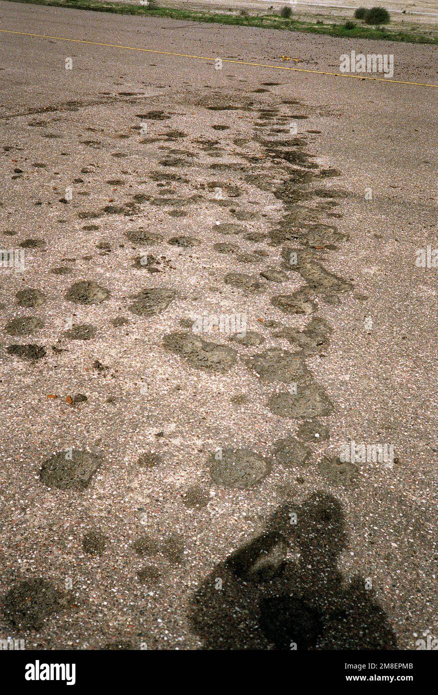 A view of an apron at the Al Jaber Airfield damaged during Operation ...