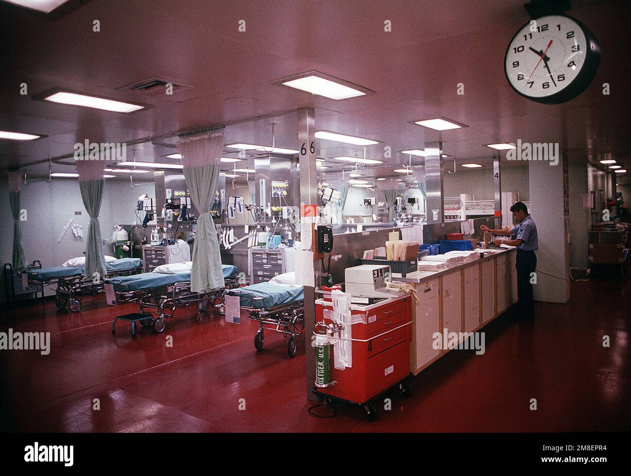 A corpsman review a chart in a ward aboard the hospital ship USNS ...