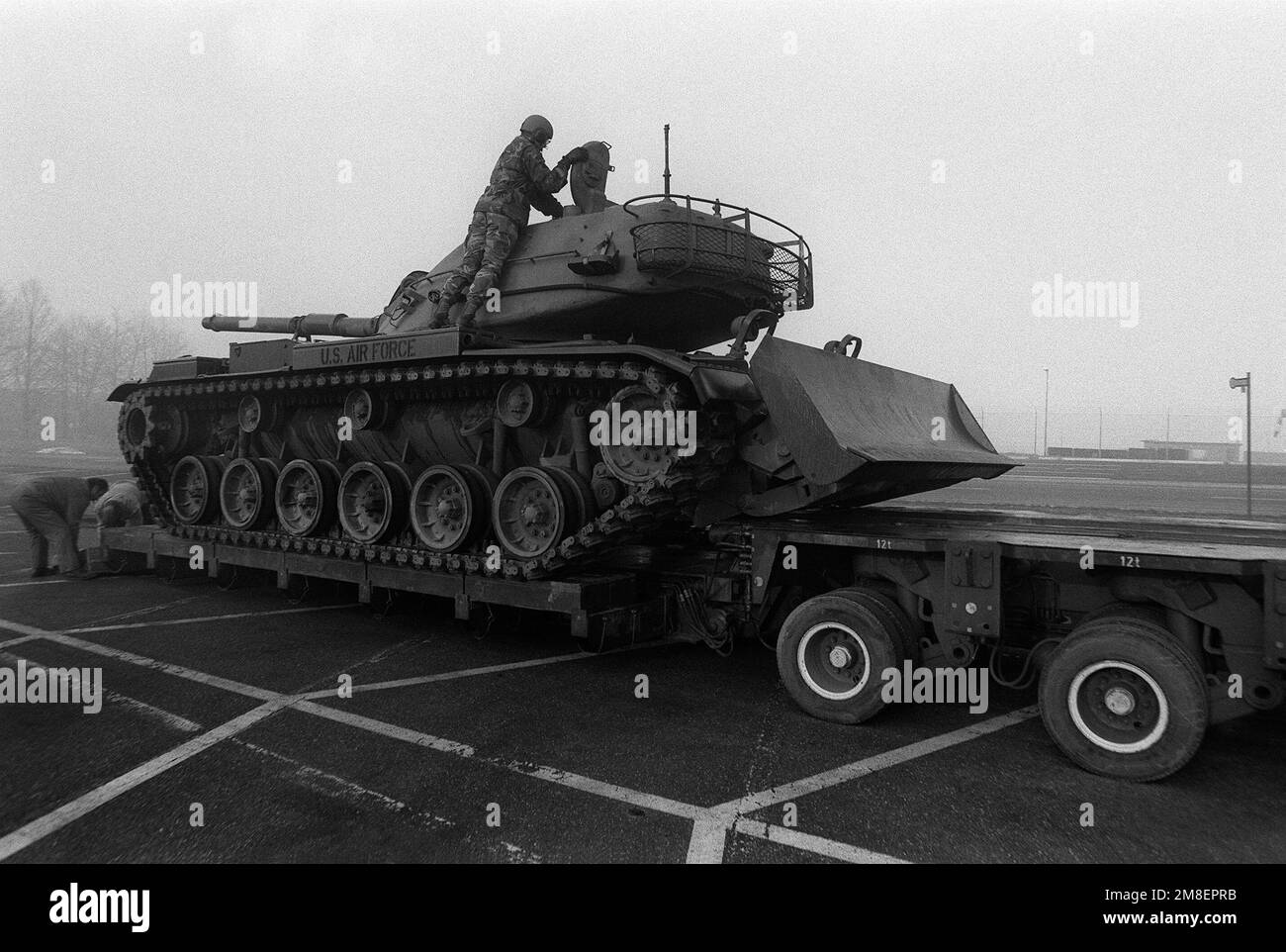 The driver of an Air Force M-60A3 main battle tank checks inside its ...