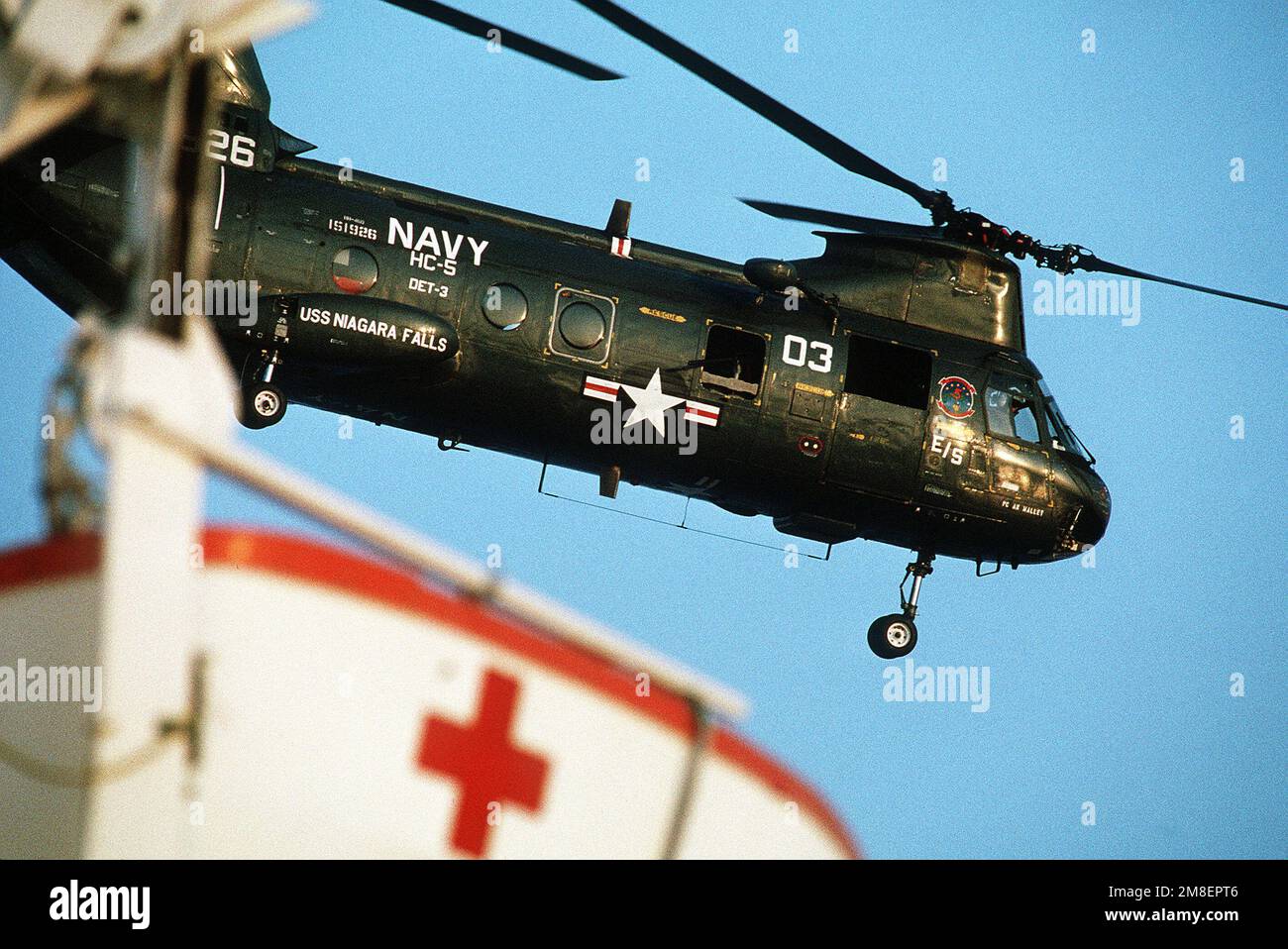A UH-46 Sea Knight helicopter conducts vertical replenishment ...