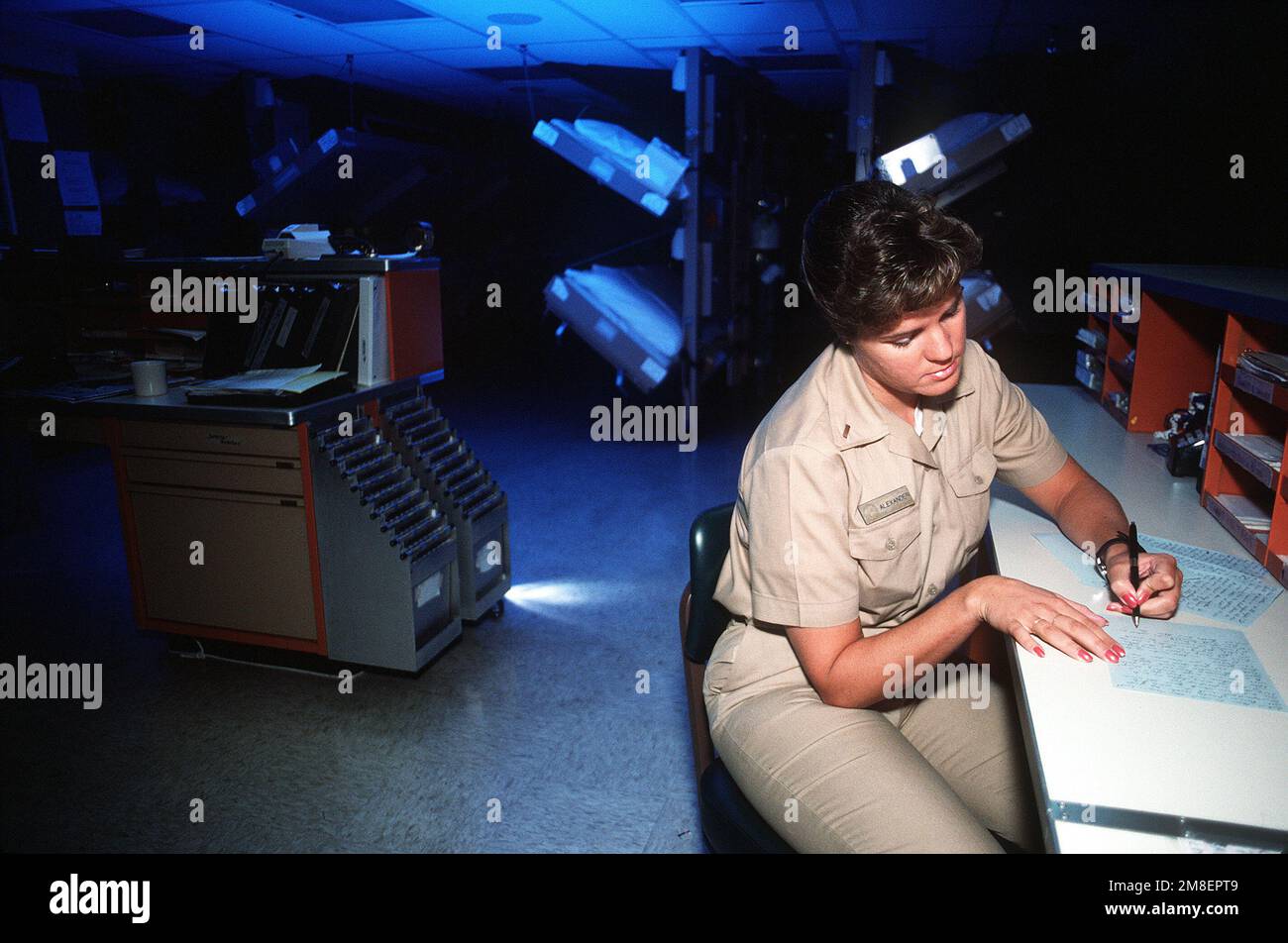 LT. j.g. Sarah Alexander tends to paperwork aboard the hospital ship ...