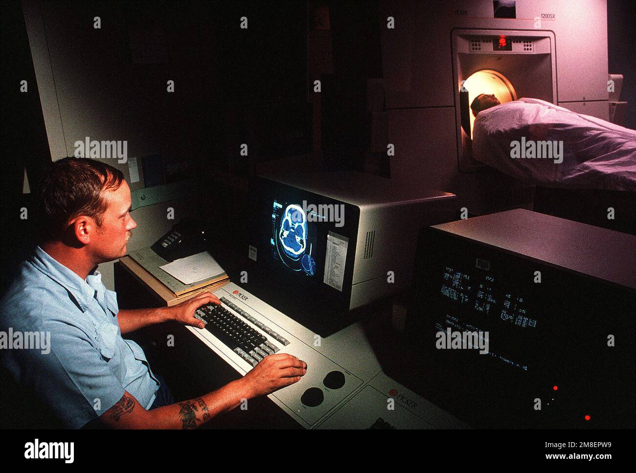 Hospital corpsman 1ST Class (SW) Paul Gunther operates a computerized ...