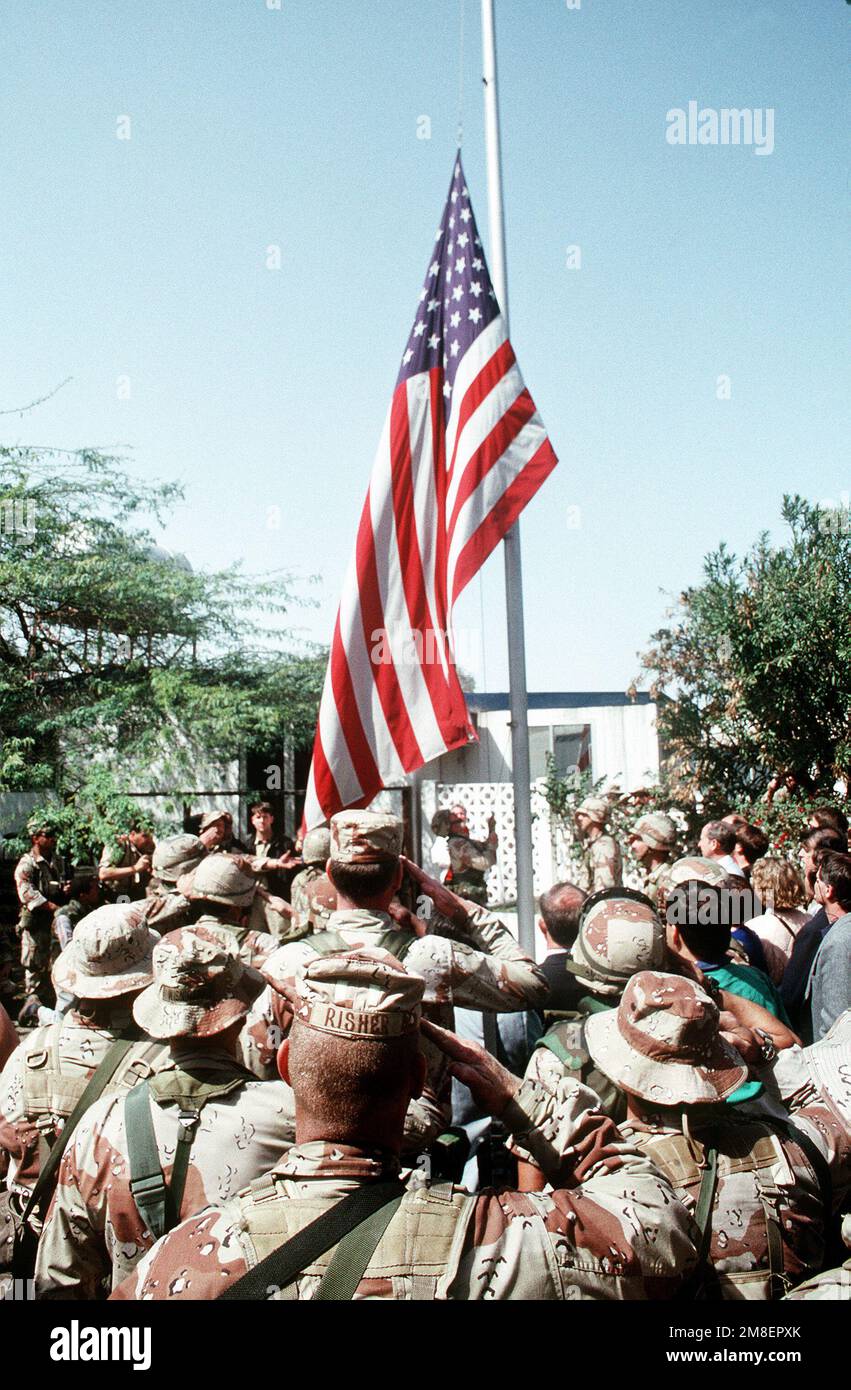 American servicemen salute as the national colors are raised again at ...
