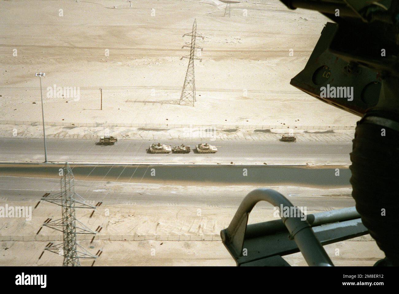 Allied armored vehicles remove an Iraqi tank from the road during ...