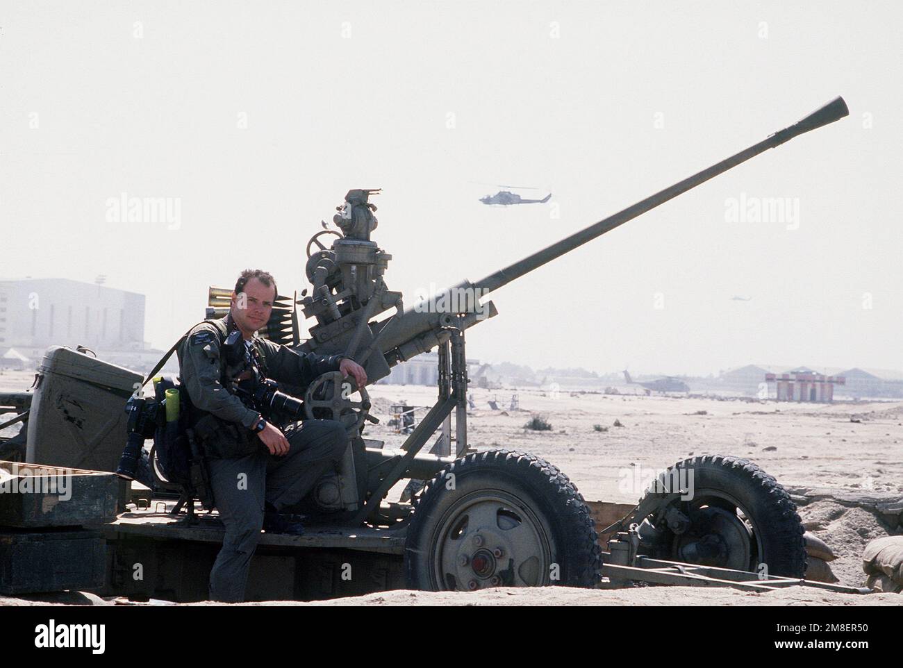 U.S. Air Force photojournalist STAFF SGT. F. Lee Corkran sits on an ...