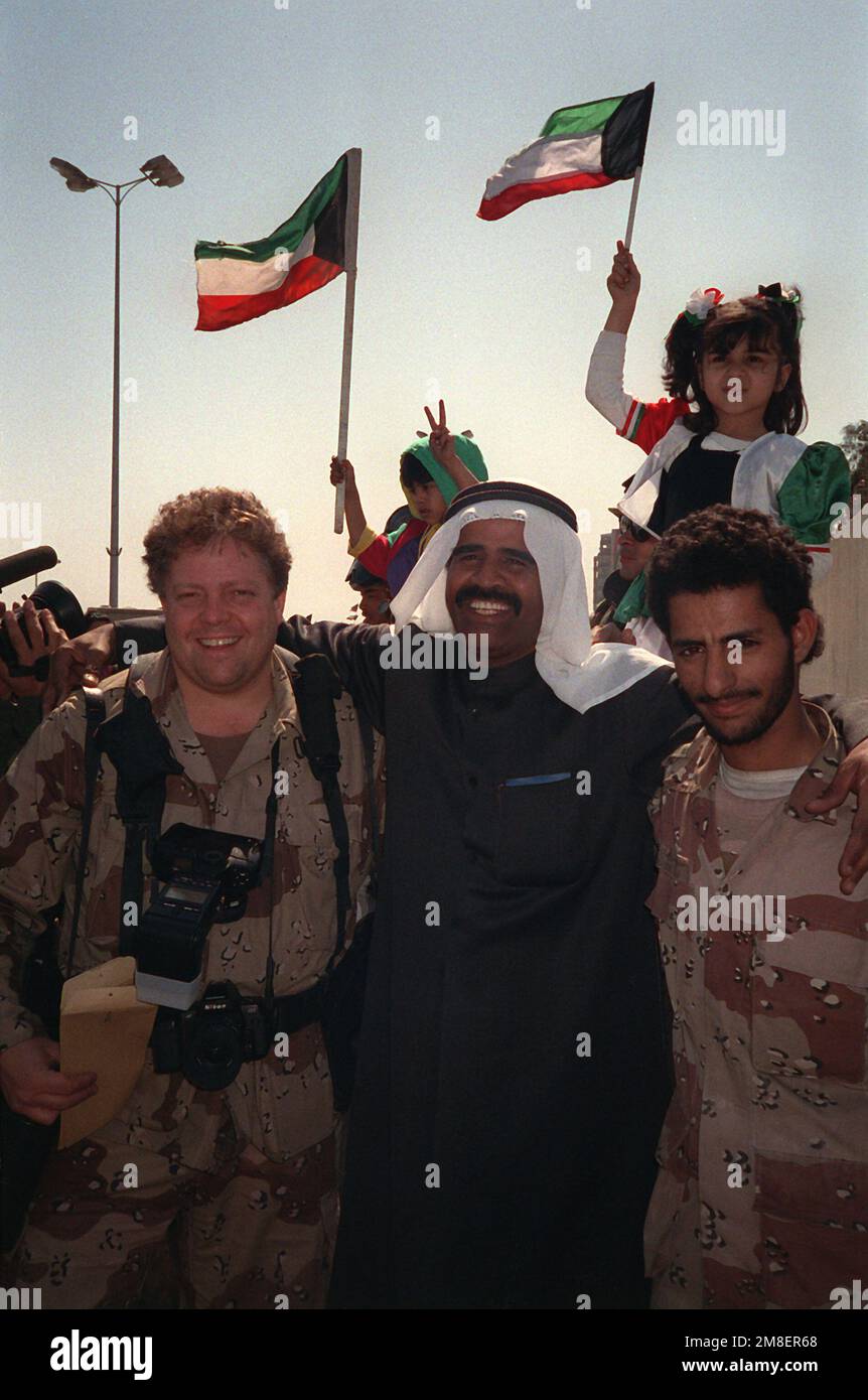 Children wave Kuwaiti flags as civilians and coalition military forces ...