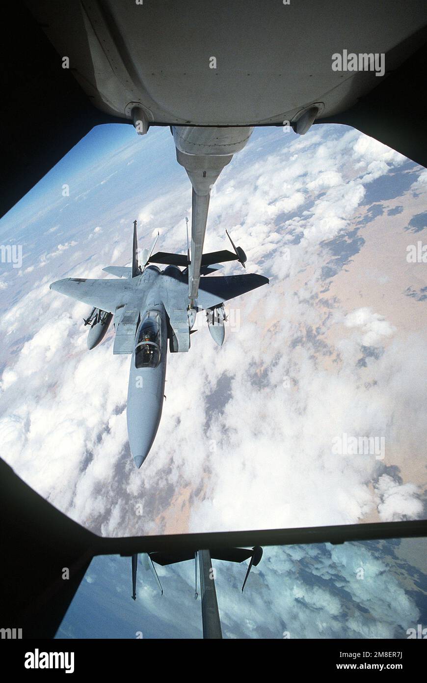 An F-15C Eagle aircraft refuels from a KC-10A Extender aircraft while ...