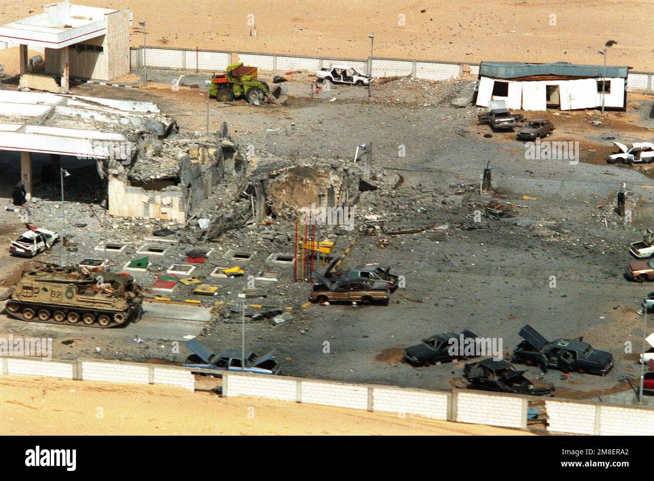 An M-88 armored recovery vehicle is parked next to a destroyed service ...