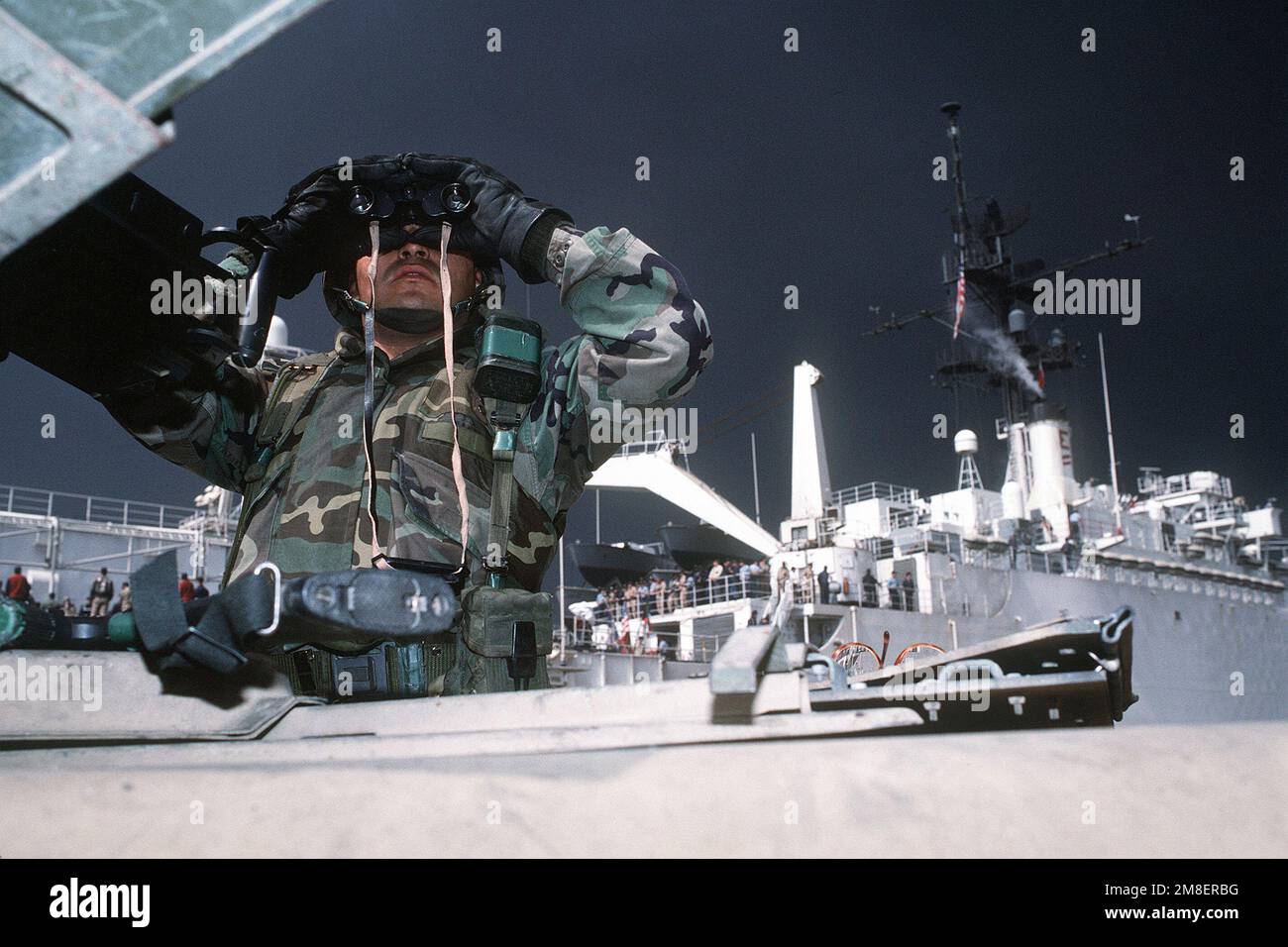 An Army military policeman keeps watch from the roof of an M998 High ...