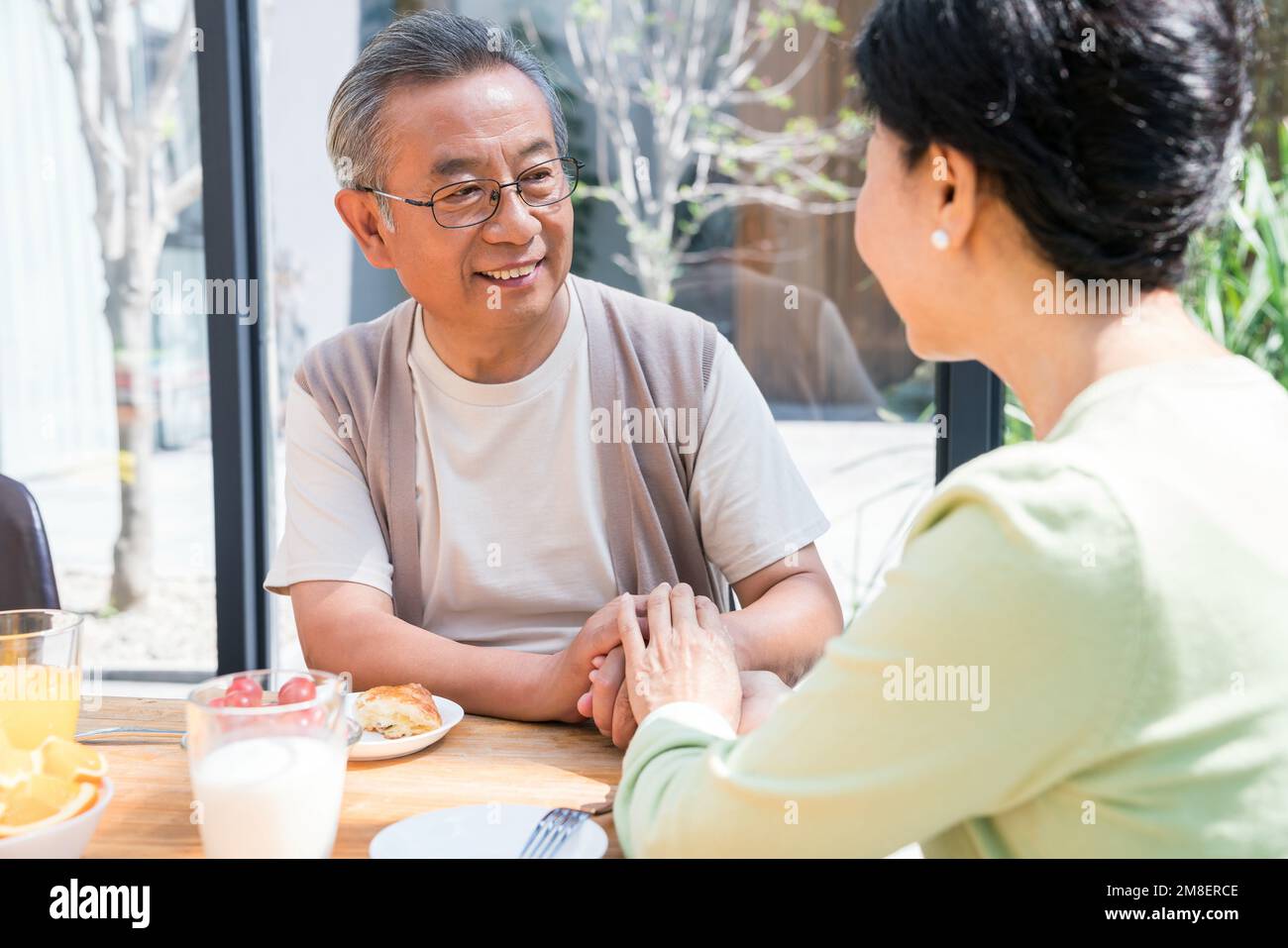 An old couple to eat breakfast Stock Photo - Alamy