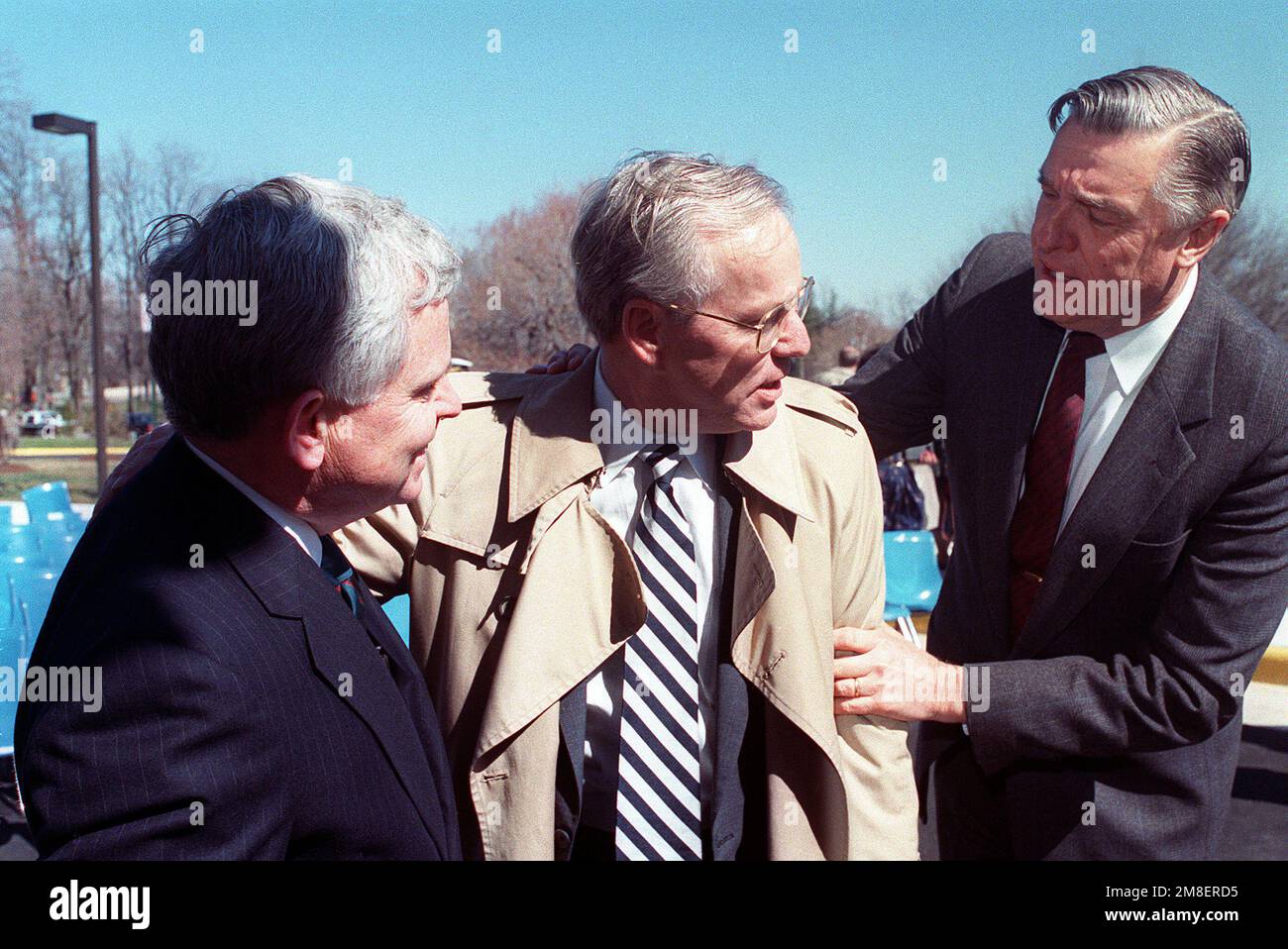 Secretary of the Navy H. Lawrence Garrett III, center, talks with two ...