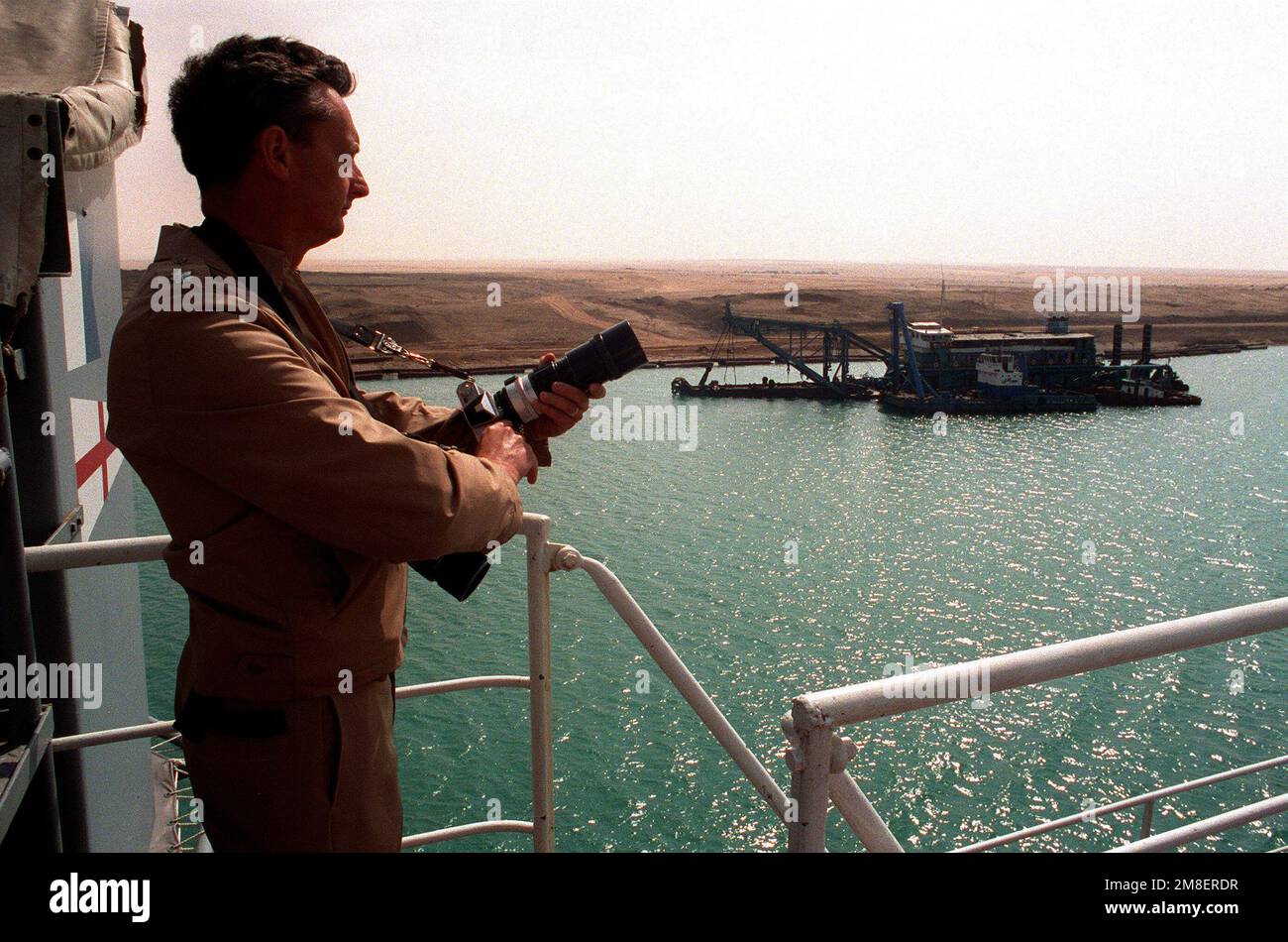 CMDR. John Charles Roach, a U.S. Navy artist, prepares to photograph ...