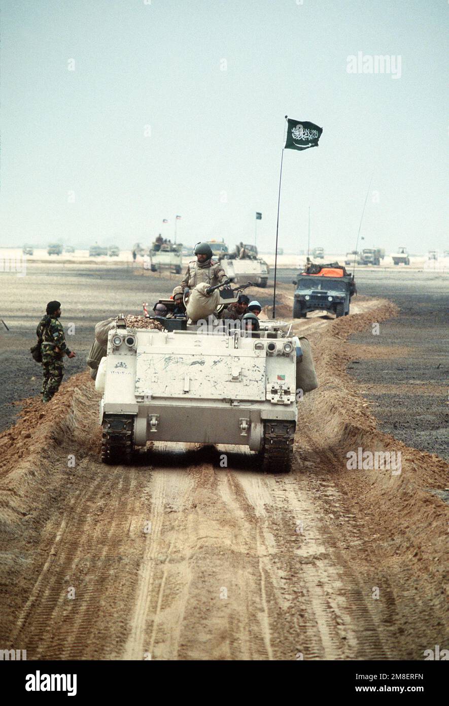 A column of M-113 armored personnel carriers and other military ...