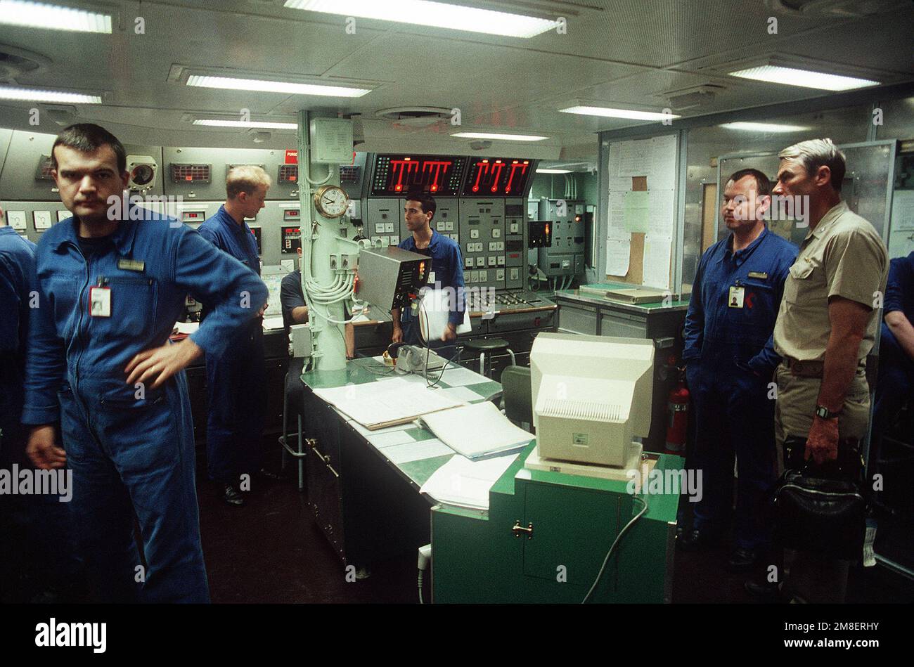 CAPT. Douglas C. Bauer, a Naval historian, tours the engine room of the ...