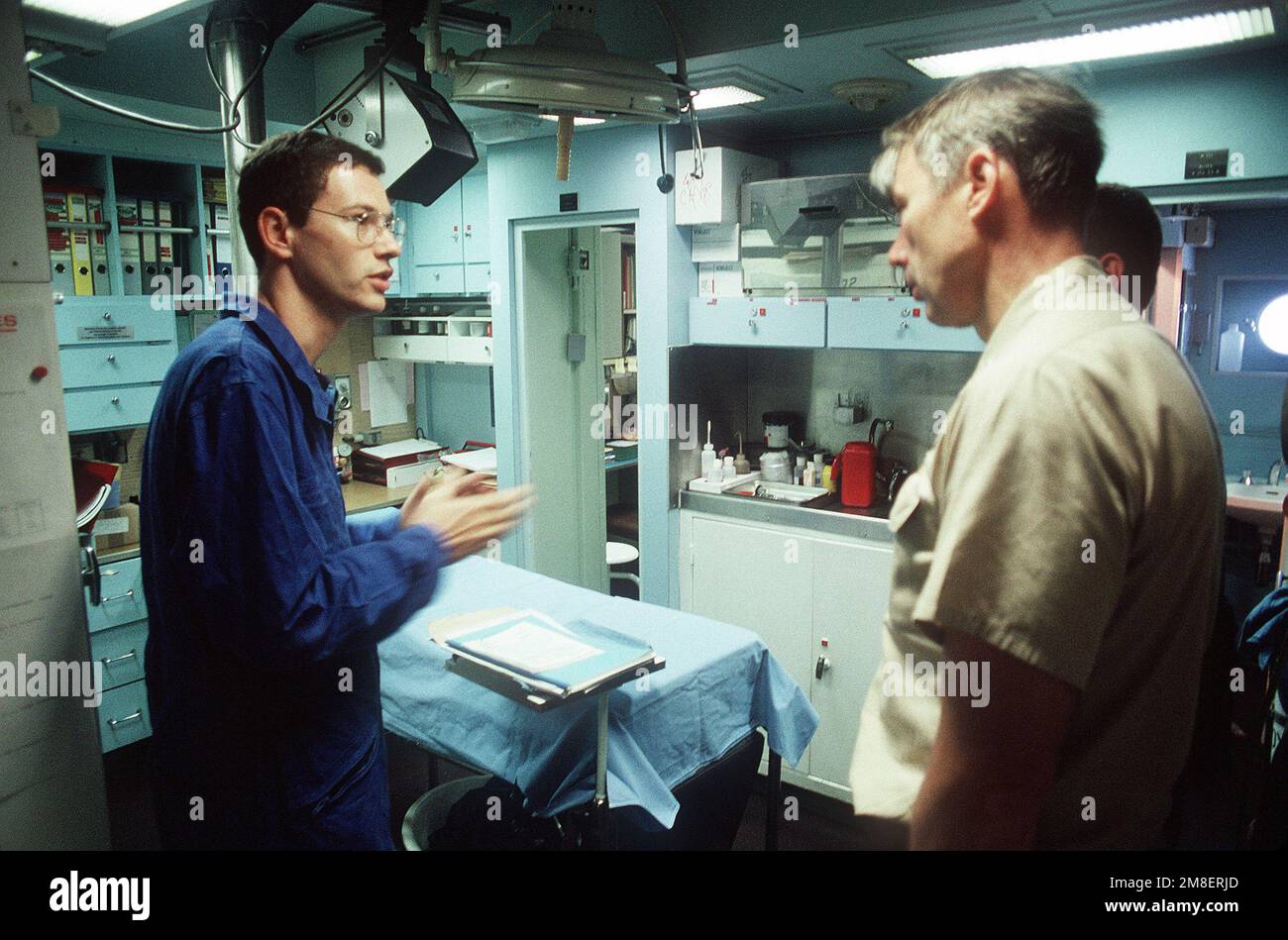 CAPT. Douglas C. Bauer, a Naval historian, speaks with the ship's ...