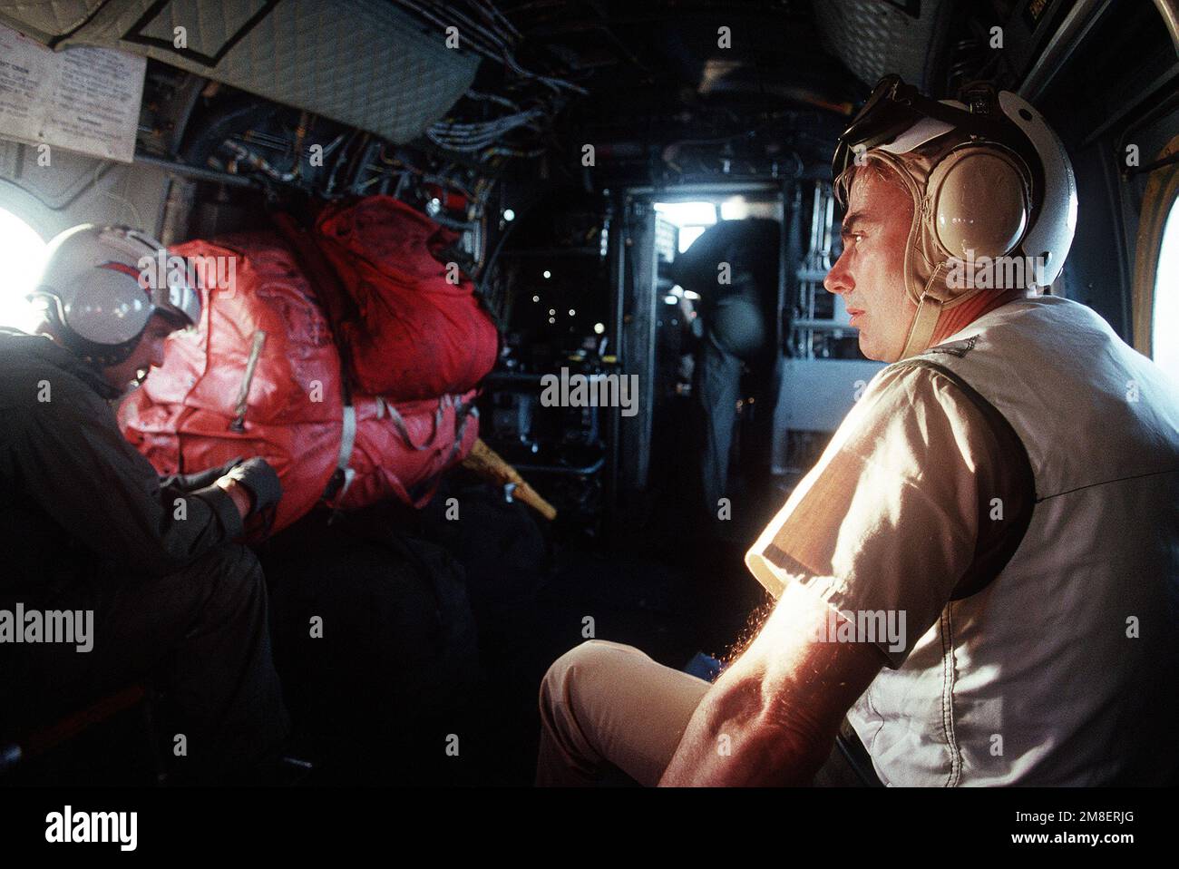 CAPT. Douglas C. Bauer, a Naval historian, is transported by CH-46 Sea ...