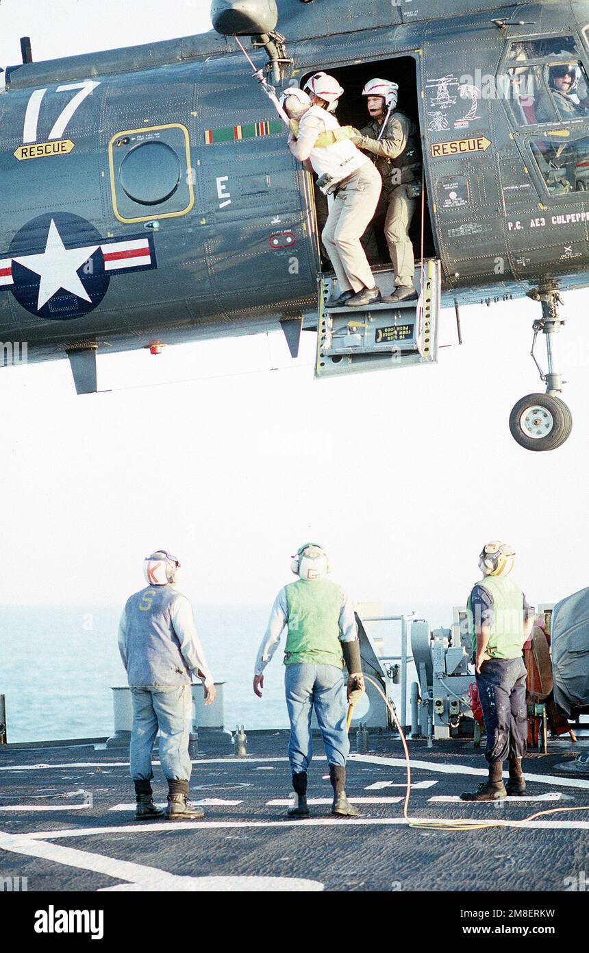 Crew members stand by to assist as CAPT. Douglas C. Bauer, a Naval ...