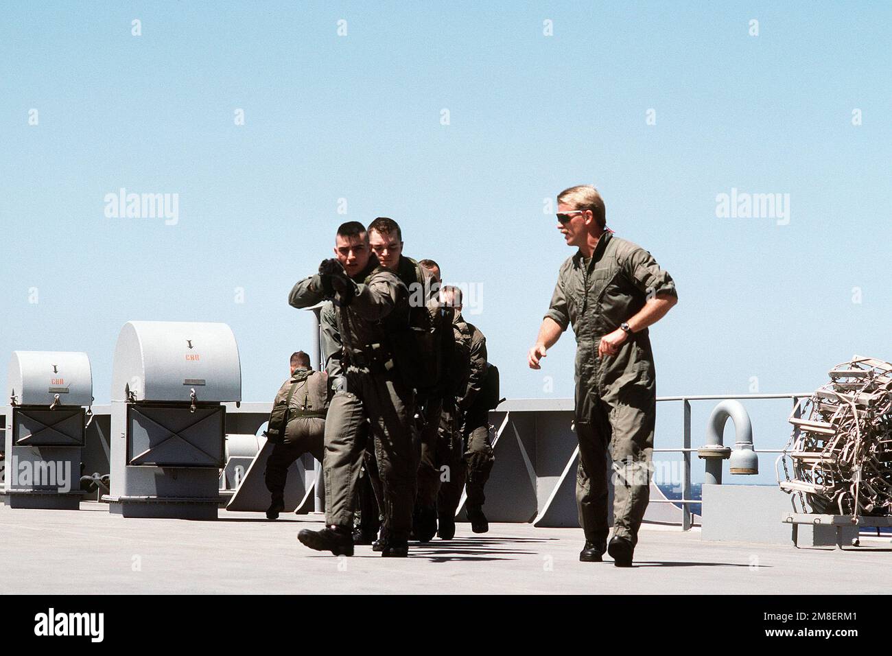 A member of Sea-Air-Land (SEAL) Team 8 leads members of the Marine ...