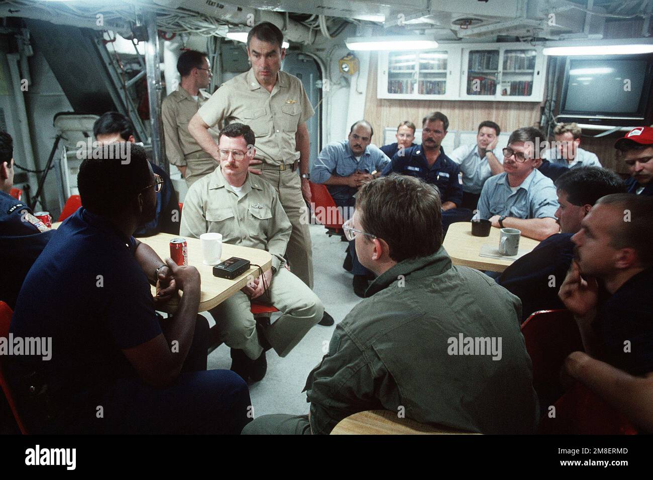 CAPT. Douglas C. Bauer, a Naval historian, converses with crew members ...