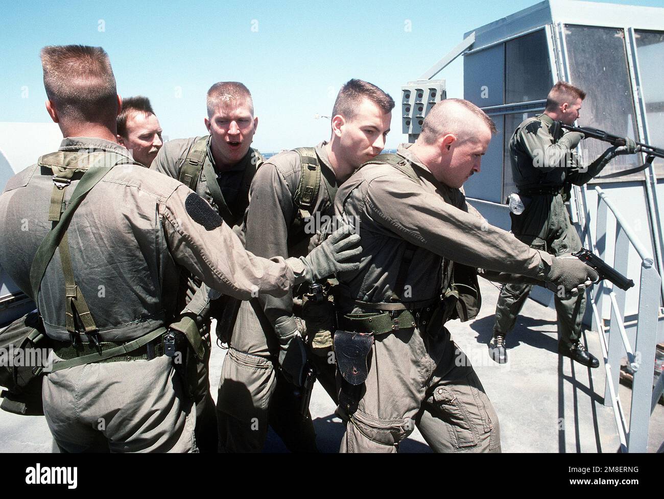 A member of Sea-Air-Land (SEAL) Team 8, left, gives instructions to ...