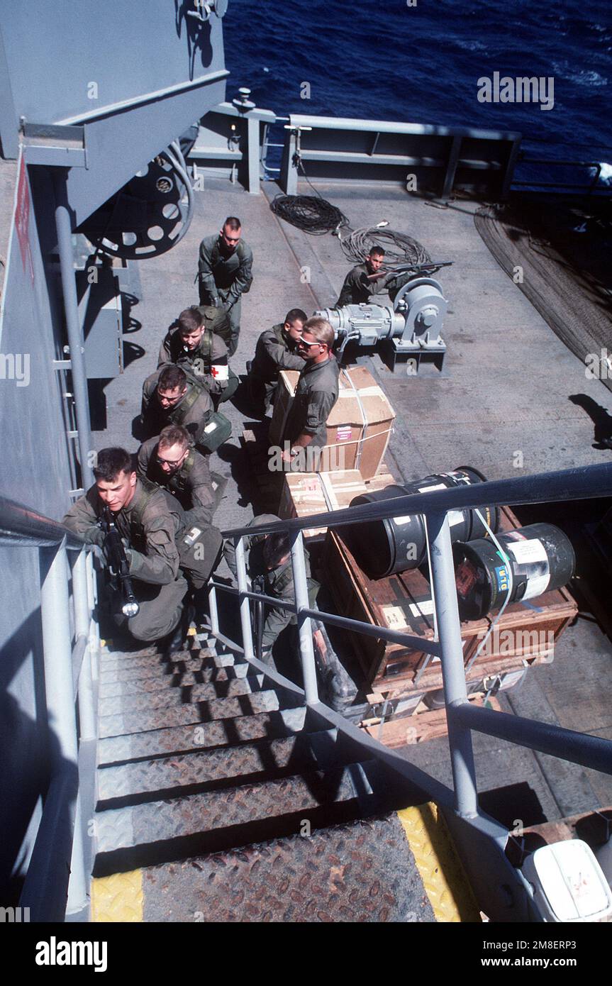 A member of the Sea-Air-Land (SEAL) Team 8, center, looks on as members ...