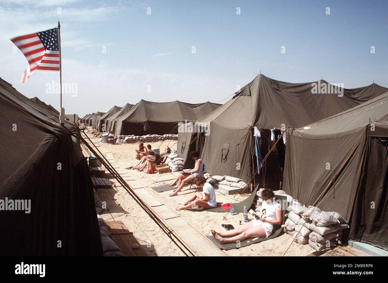 Off-duty nurses relax outside their tents at Fleet Hospital 15. The ...