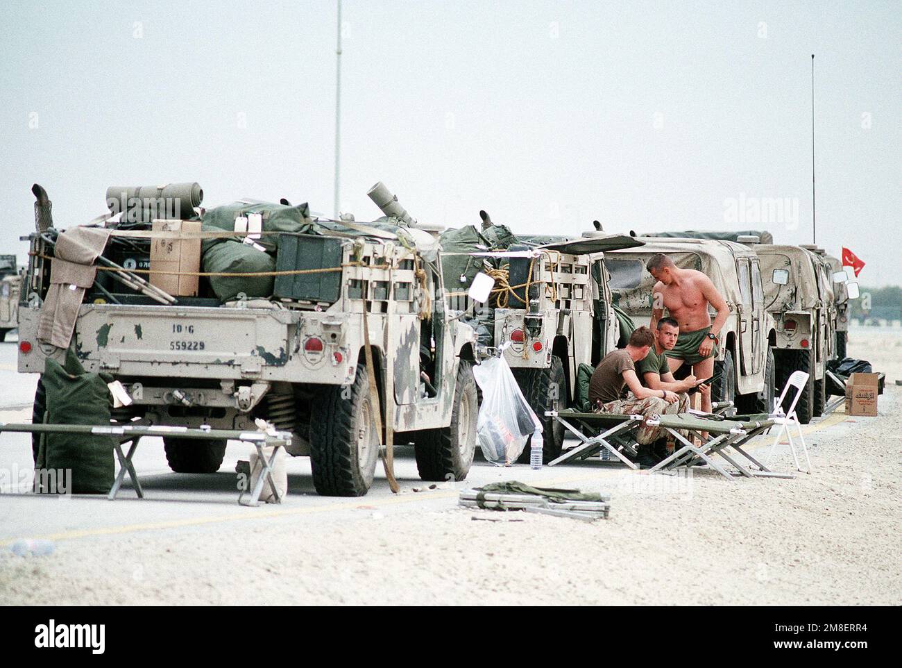 Marines wait beside their M998 High-Mobility Multipurpose Wheeled ...