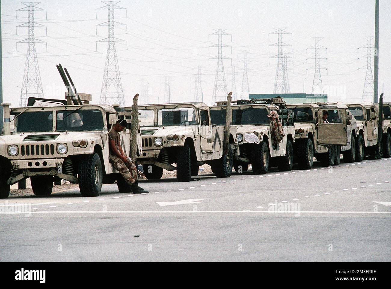Drivers sit in their M998 High-Mobility Multipurpose Wheeled Vehicles ...