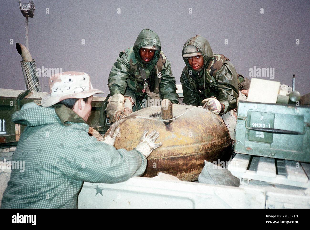 Members of a U.S. Army explosive ordnance disposal (EOD) team pull a ...