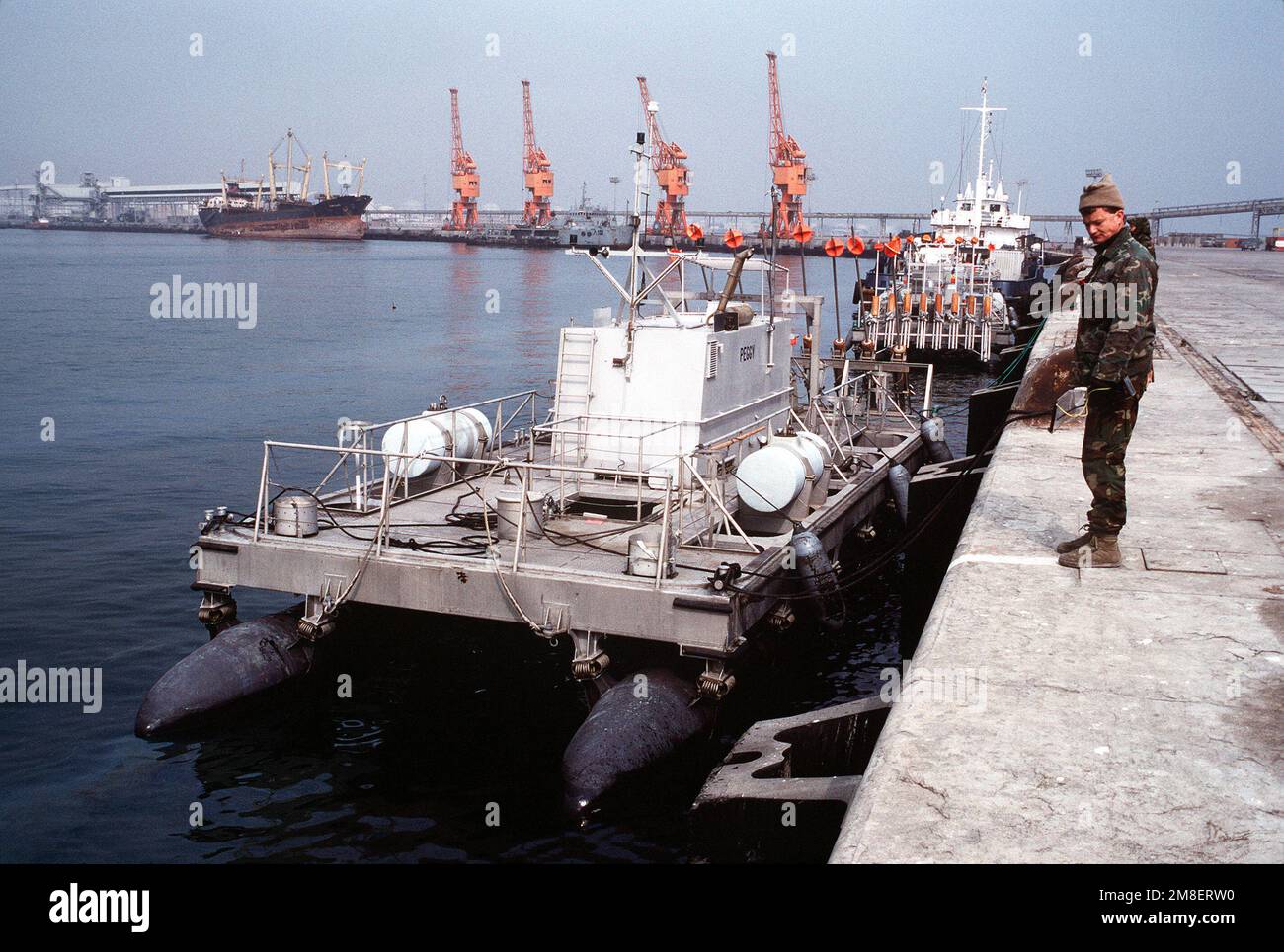 A member of a multinational explosive ordnance disposal (EDD) team ...