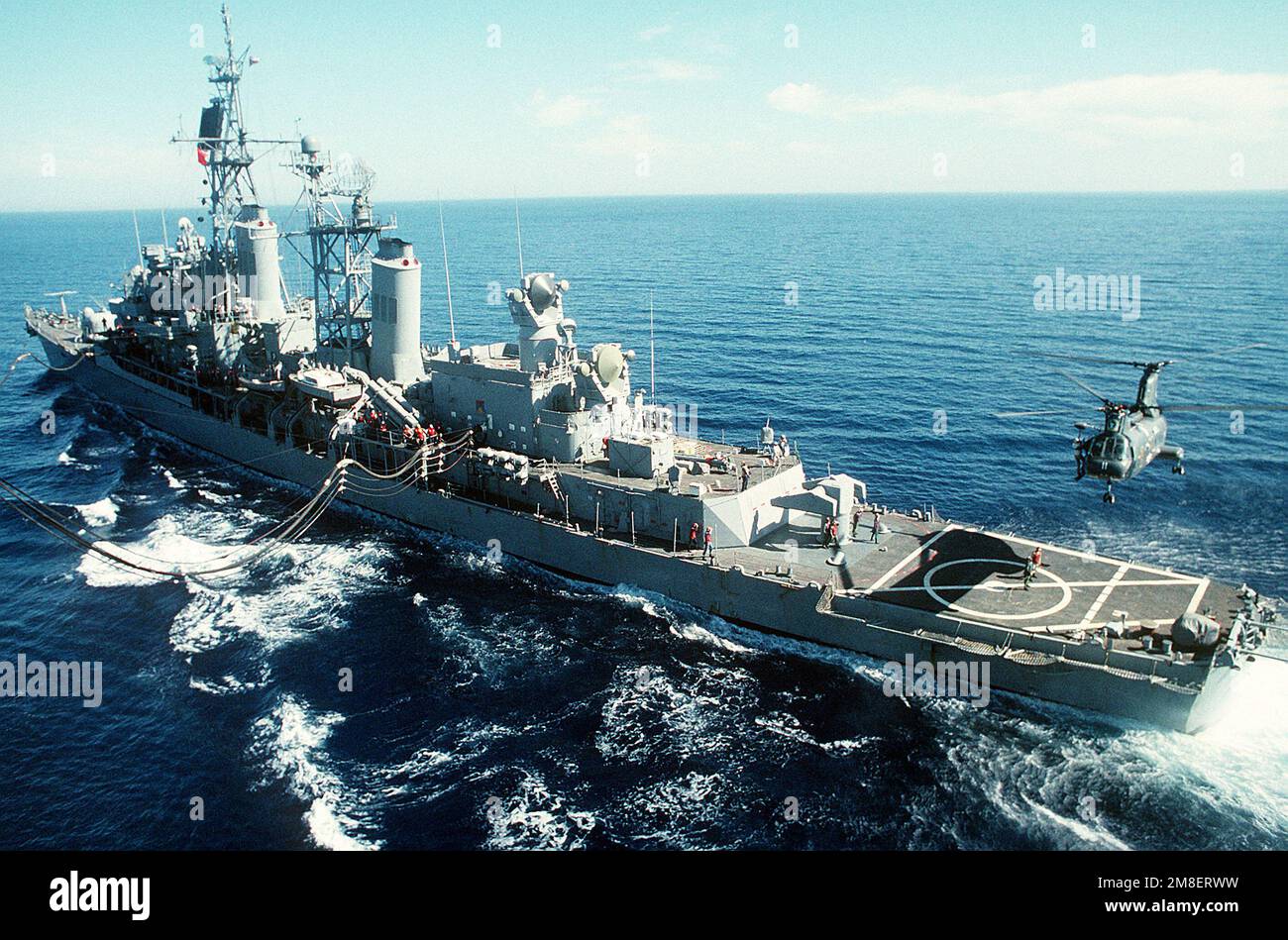 The guided missile destroyer USS WILLIAM V. PRATT (DDG-44) takes on ...