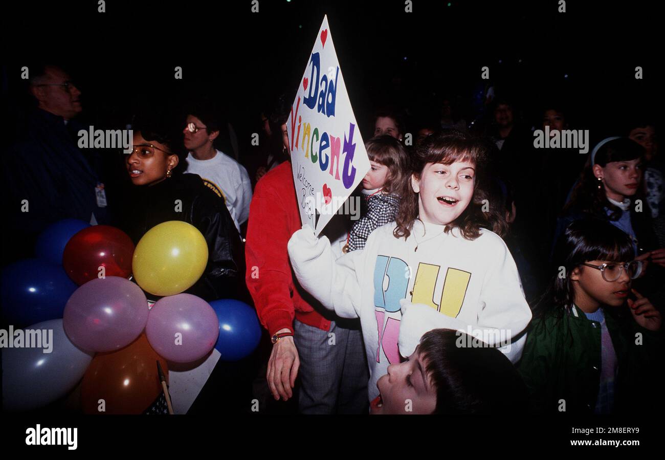 Kate Vincent waves a banner in celebration of her father's homecoming ...