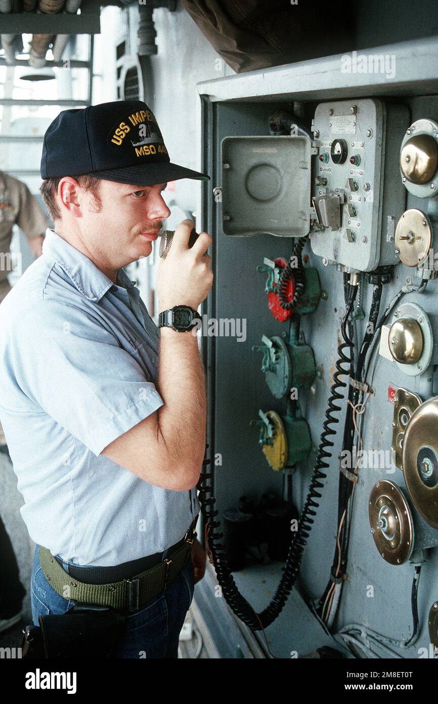 A crew member aboard the ocean minesweeper USS IMPERVIOUS (MSO-449 ...