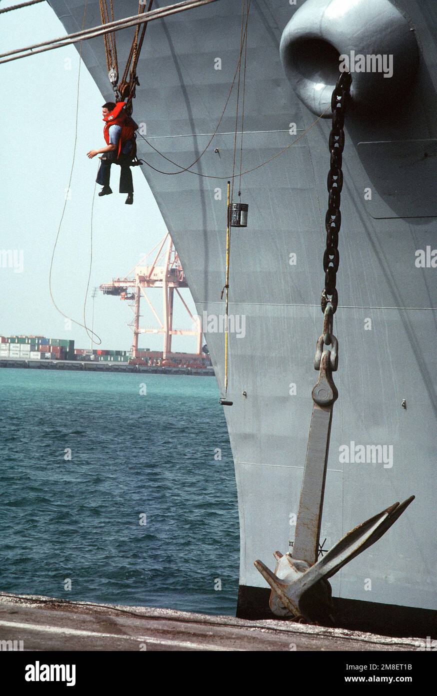 A sailor prepares to touch up the paint on a U.S. Navy ship during ...