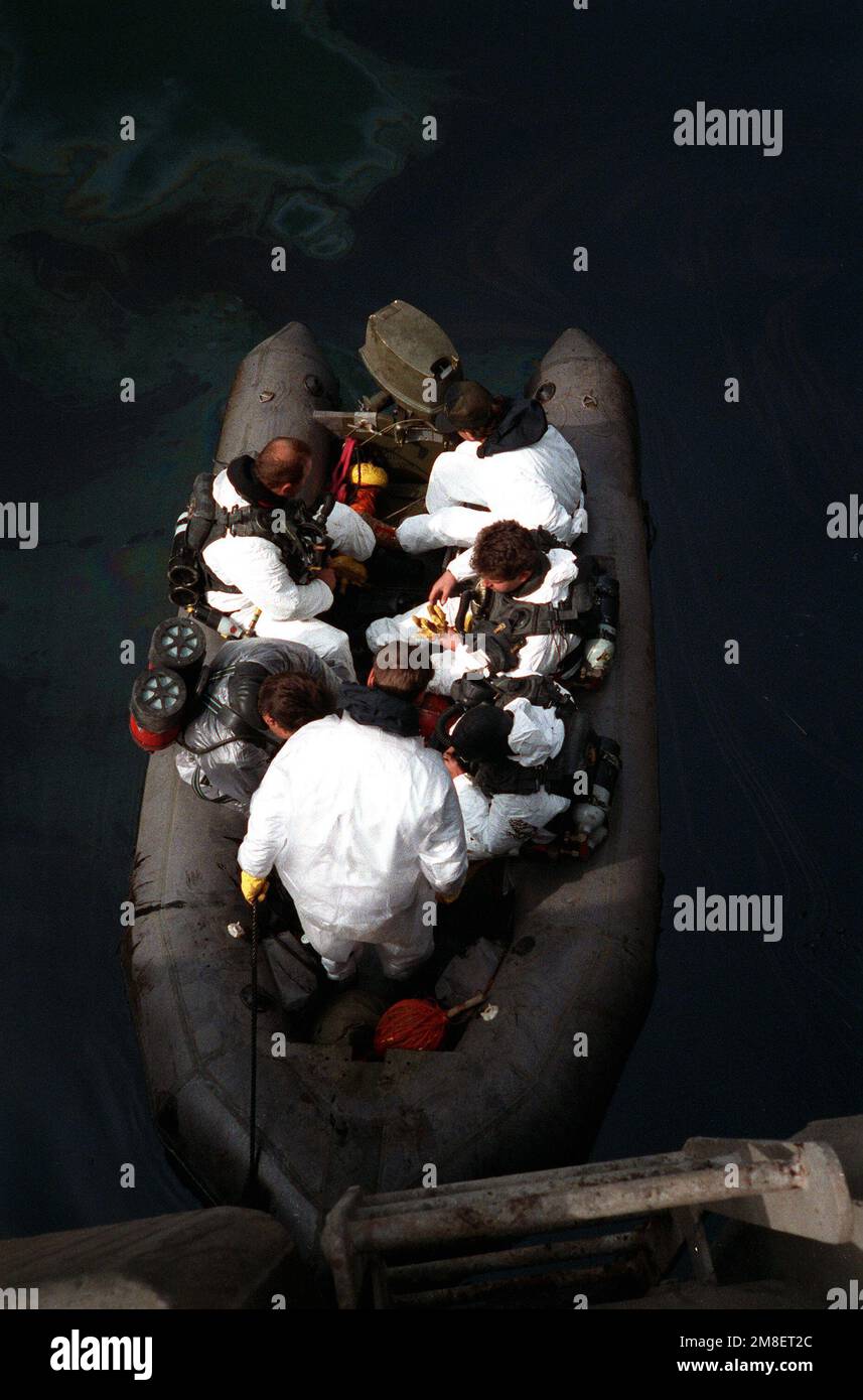 British explosive ordnance disposal (EOD) team members prepare to move ...
